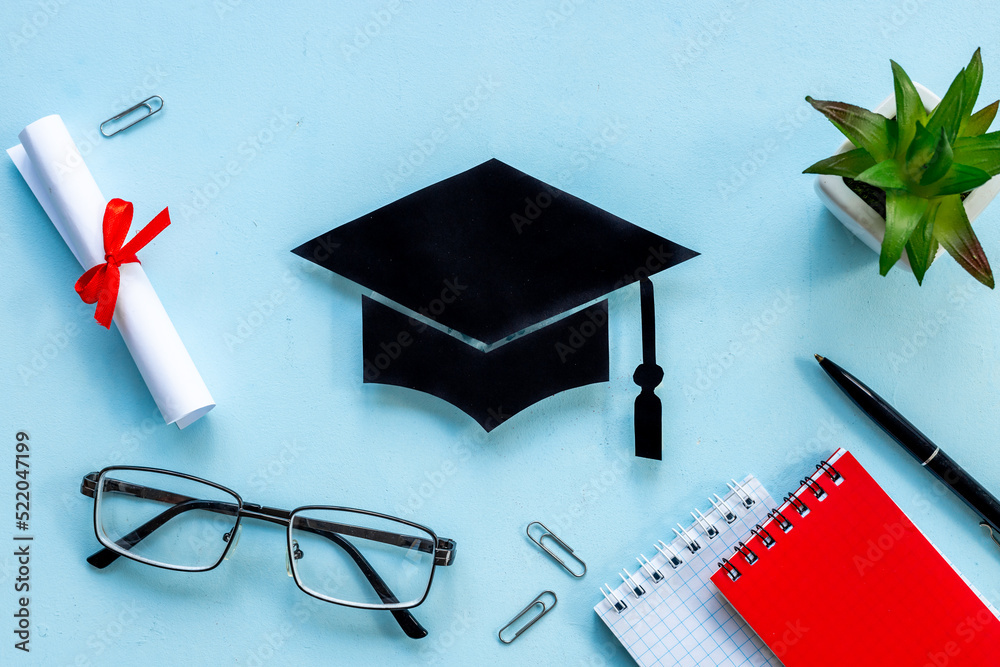 Black academic cap or graduation hat on students table, top view Stock ...