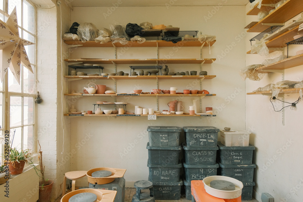 In the ceramic studio. Photo of the wall-mounted shelves filled with ...