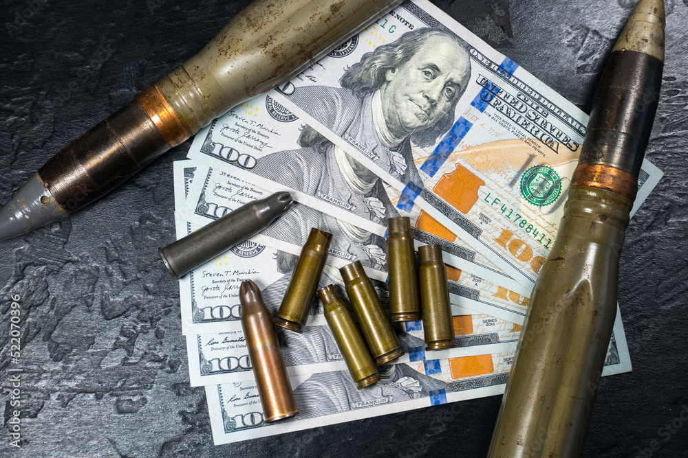 Dollars money, bullets, shells, cartridges and projectiles on black ...