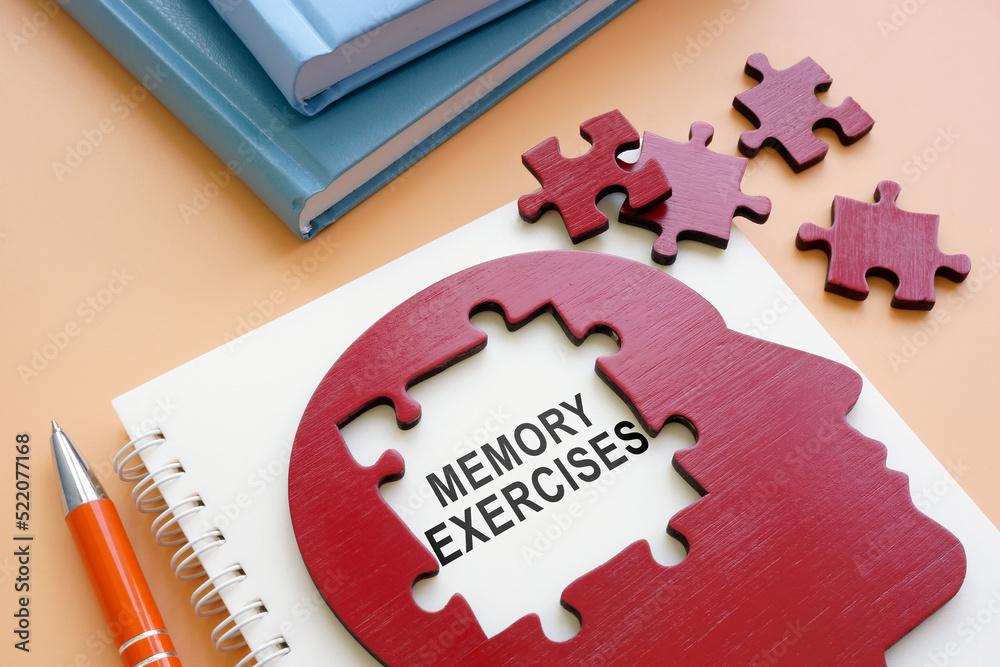 Book memory exercises and head shape with puzzle. Stock Photo | Adobe Stock