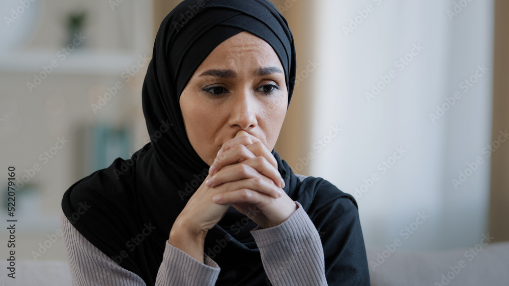 Upset sad girl in hijab sit alone get bad news feel depressed ...
