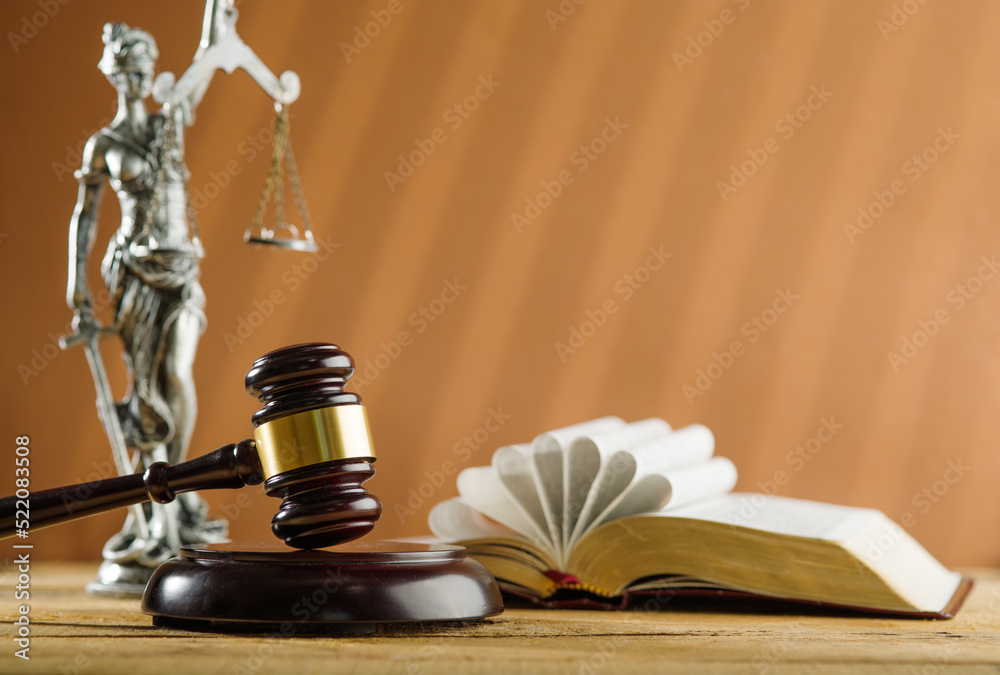 Symbols of a fair trial. An open book - the Bible, a wooden gavel of a ...
