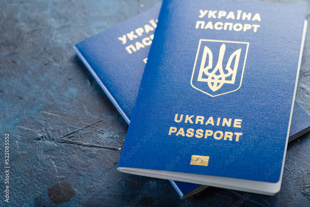 Close-up. Two Ukrainian passports on a dark blue background. Symbol of ...