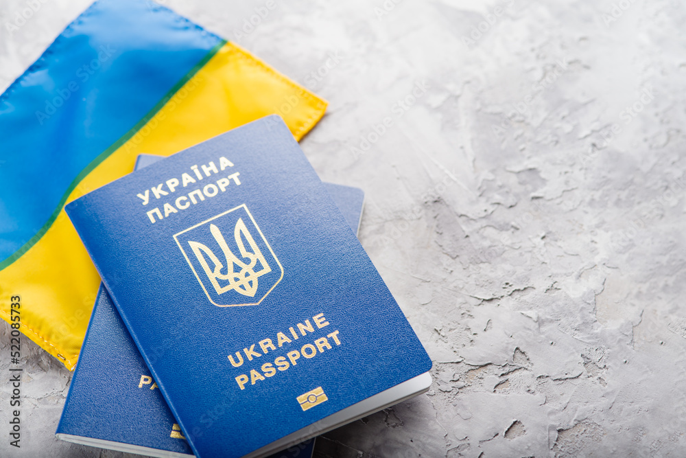 On a dark background, two Ukrainian biometric passports against the ...
