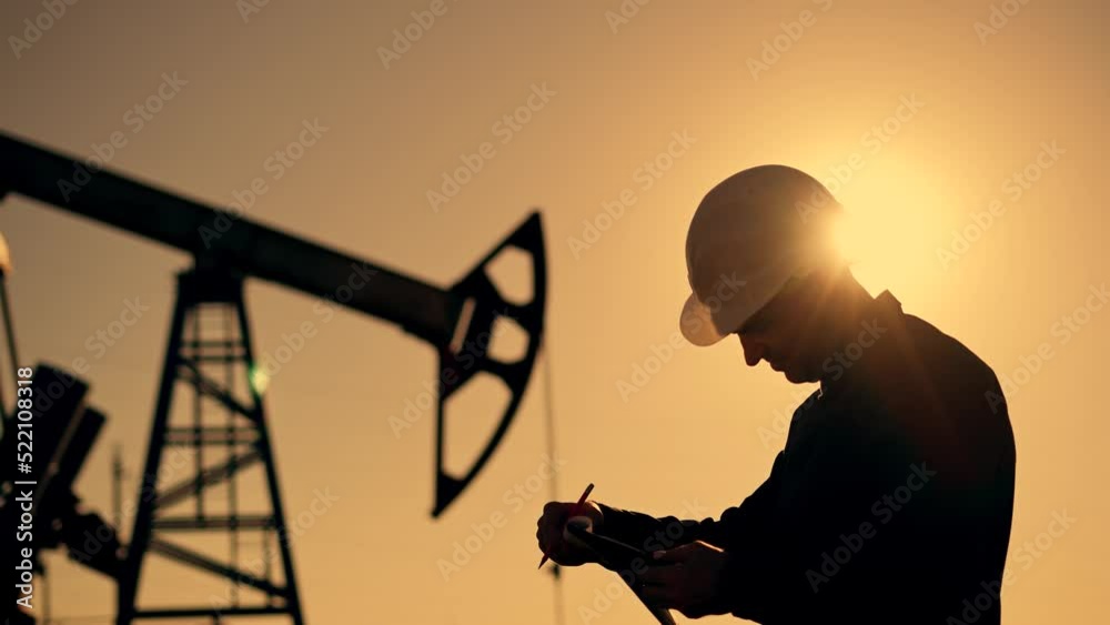 Oil pump.Engineer work with laptop and diagram.Checking operation of ...