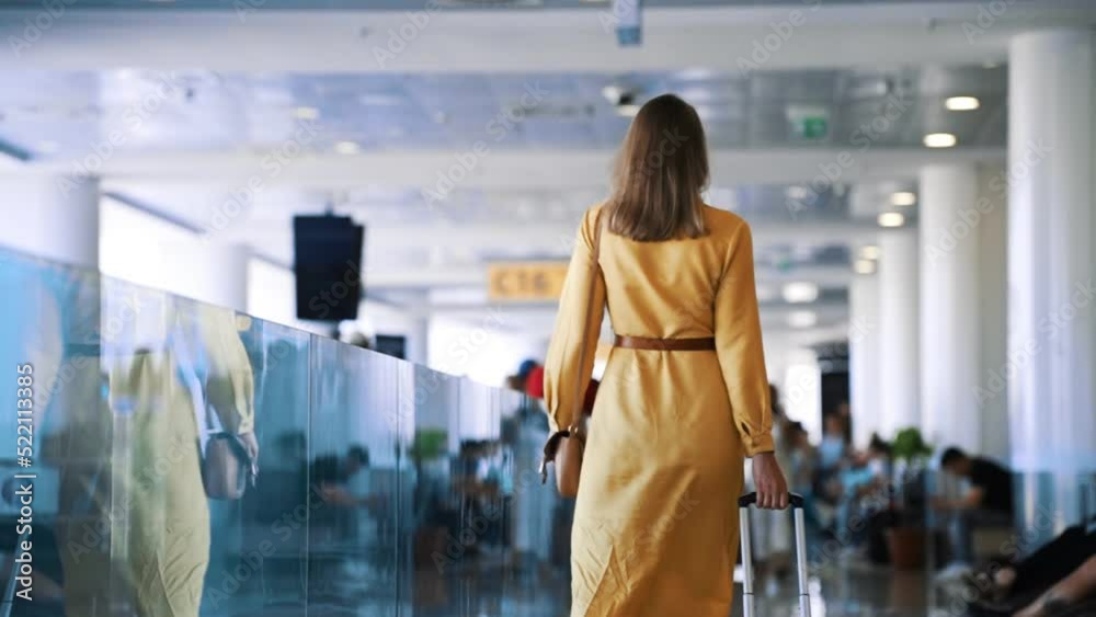 Woman walking in airport terminal. Back view. Stock Video | Adobe Stock