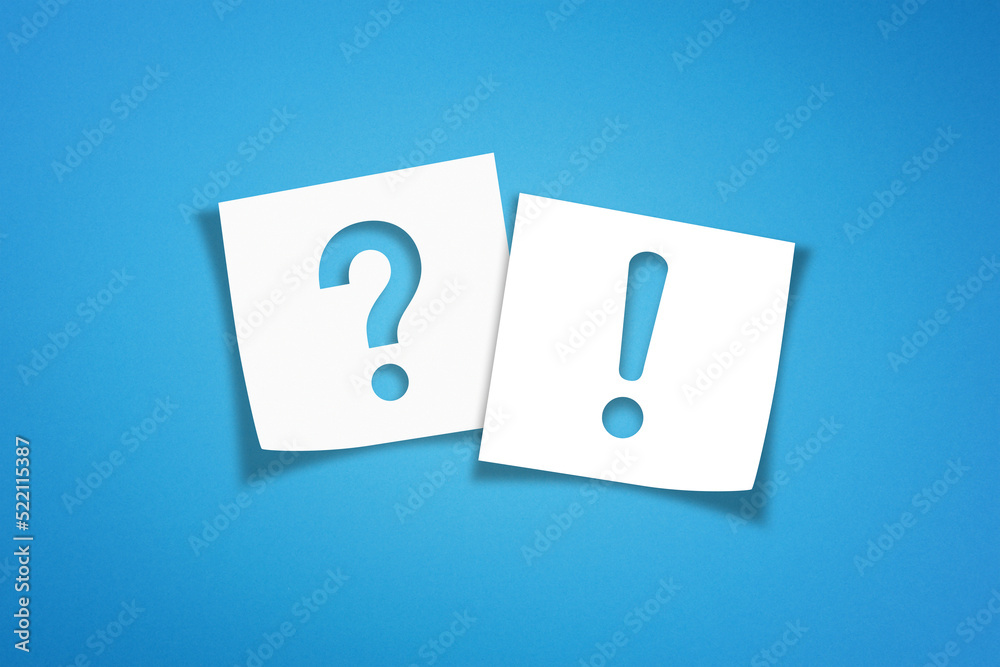 Note paper with exclamation mark and question mark on blue background ...