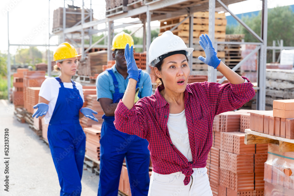 Portrait of surprised employees working in a building materials store ...