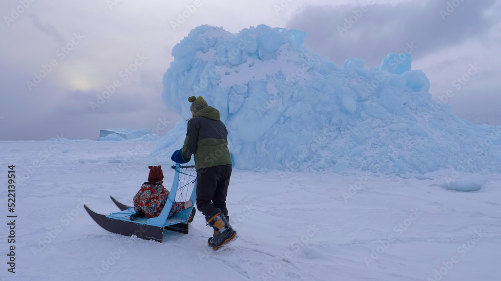 Arctic Circle Greenland sea ice, iceberg: Inuk Inuit father daughter ...