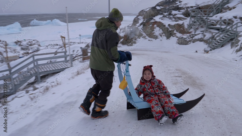 Arctic Greenland authentic daily life: Inuit father & child, sled ride ...