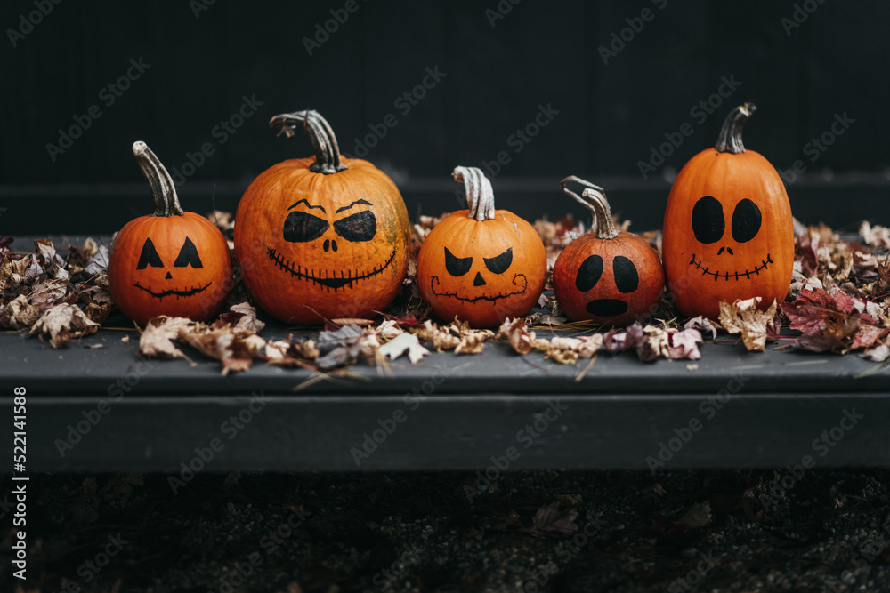 Painted pumpkin faces. Stock Photo | Adobe Stock