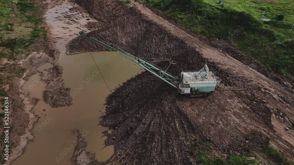 Open-pit mining. Dragline excavator load clay in freight train. Clay ...