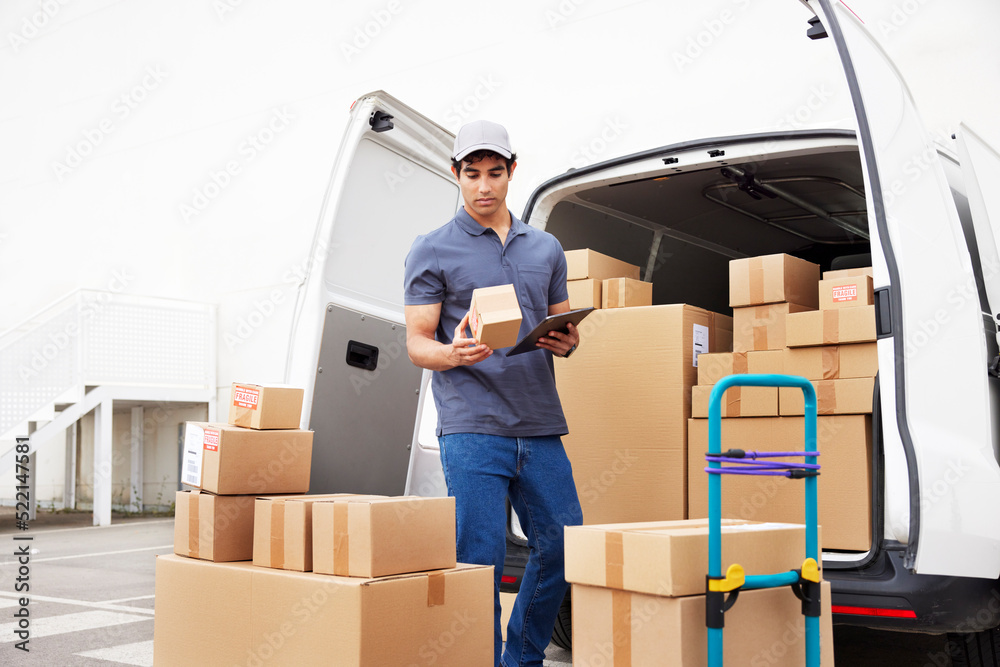 Delivery man loading van on parking lot Stock Photo | Adobe Stock
