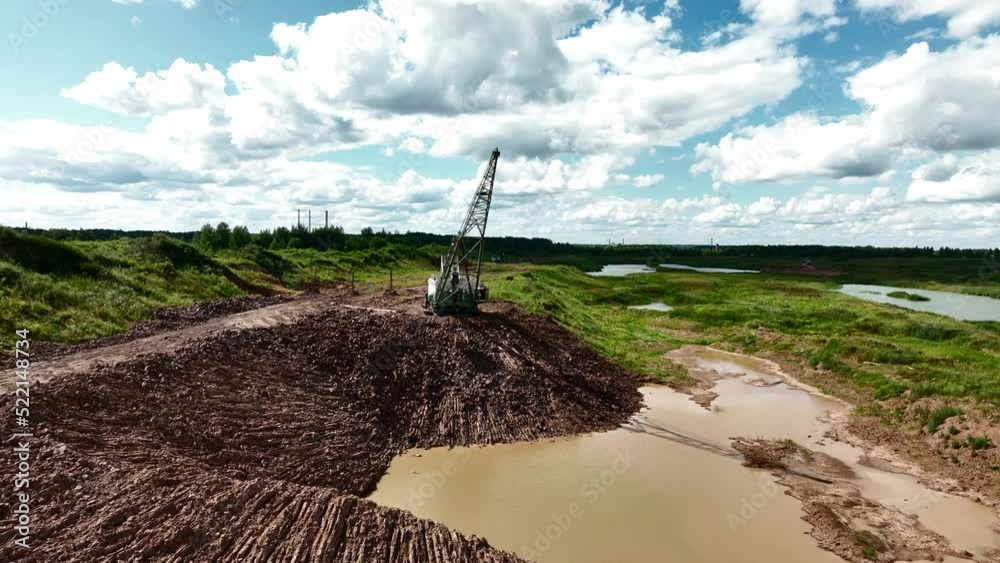 Open-pit mining. Dragline excavator load clay in freight train. Clay ...