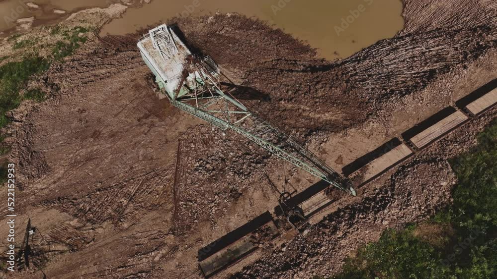 Open-pit mining. Dragline excavator load clay in freight train. Clay ...