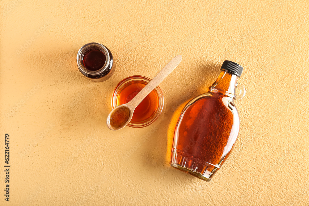 Bottles and bowl of maple syrup on color background Stock Photo | Adobe ...