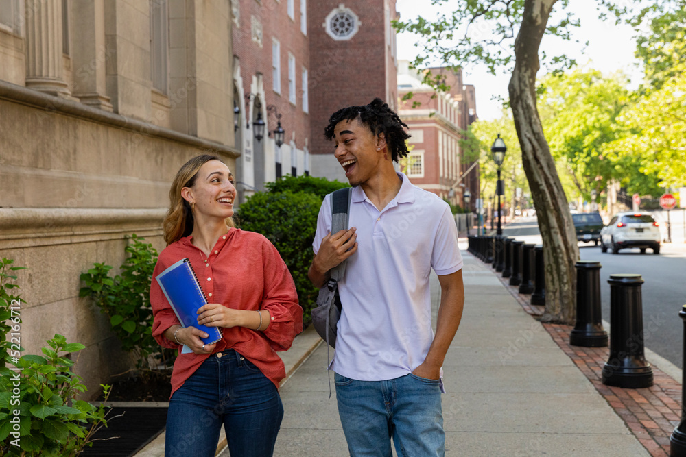 Two Gen Z Friends University Students smile together on Campus Stock ...
