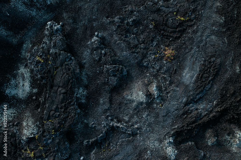 From above texture of volcano rocks and sand from lava at Mount Batur ...
