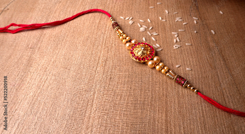 Indian Festival: Rakhi with rice grains, kumkum, sweets and haldi on ...