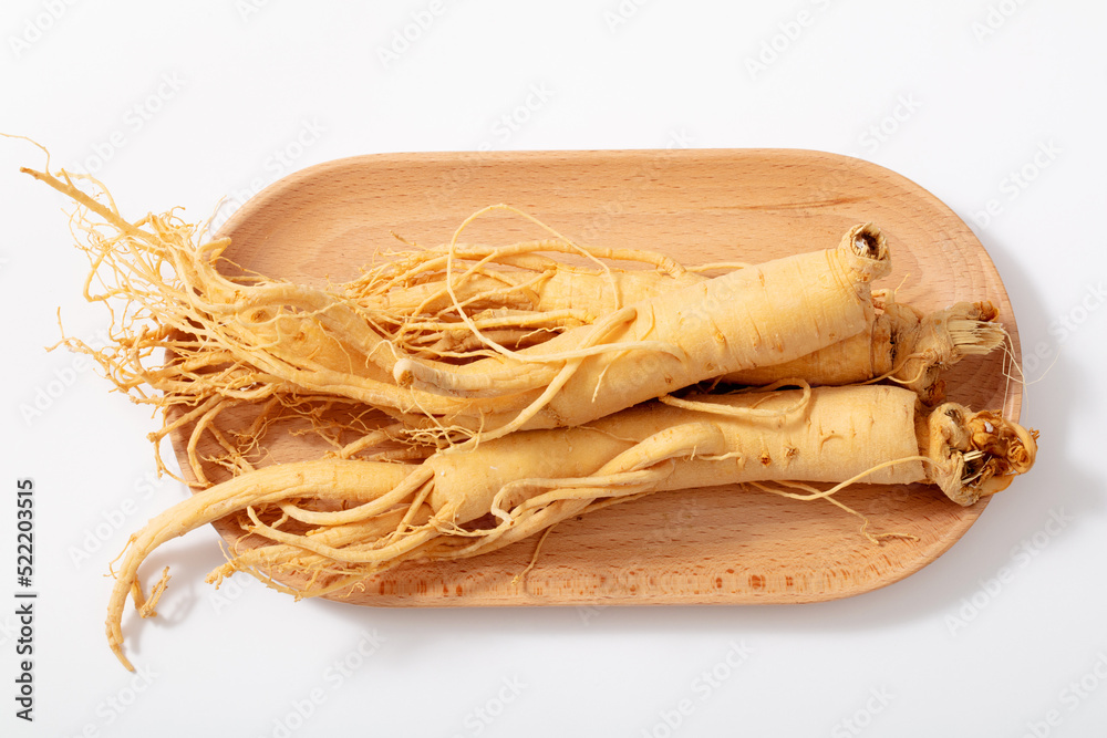 Ginseng is isolated in trays on white background. Ginseng has been used ...