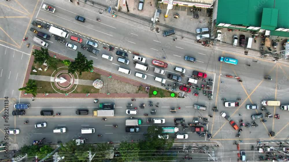 Top down drone view of traffic triangle intersection, slow moving ...