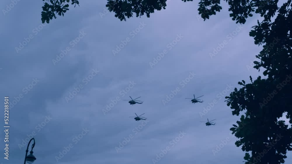 The formation of helicopters flying over the city. View of helicopters ...