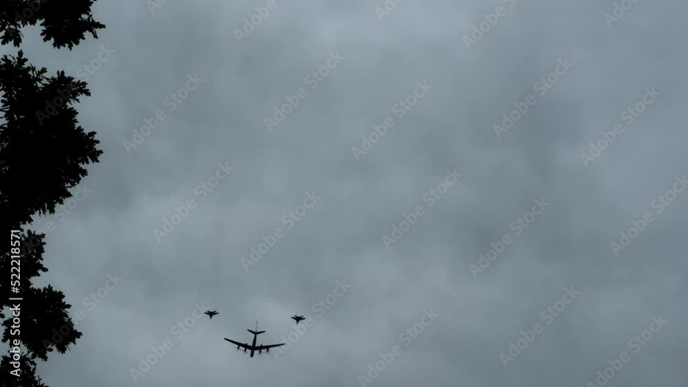 Formation of fighters and bombers flying over the city. View of combat ...
