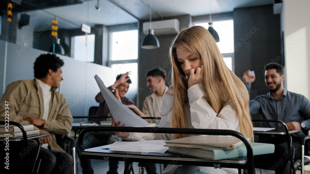 Sad frustrated insecure girl student sitting in classroom at desk ...