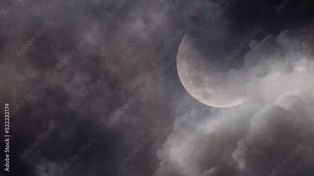 a crescent moon that appears at night with dark clouds and ...