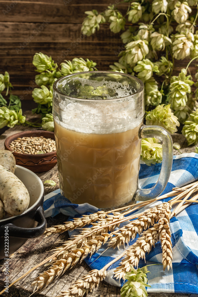 Oktoberfest set. Unfiltered beer, weisswurst, spikelets of grain, hop ...