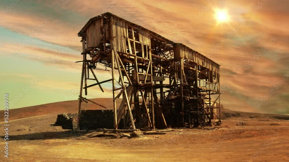 A slow motion pan and zoom of an old salt mining structure with the sun ...