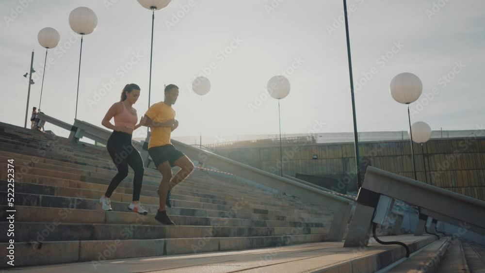 Cinematic video of urban runners athletes training outdoor in a modern ...