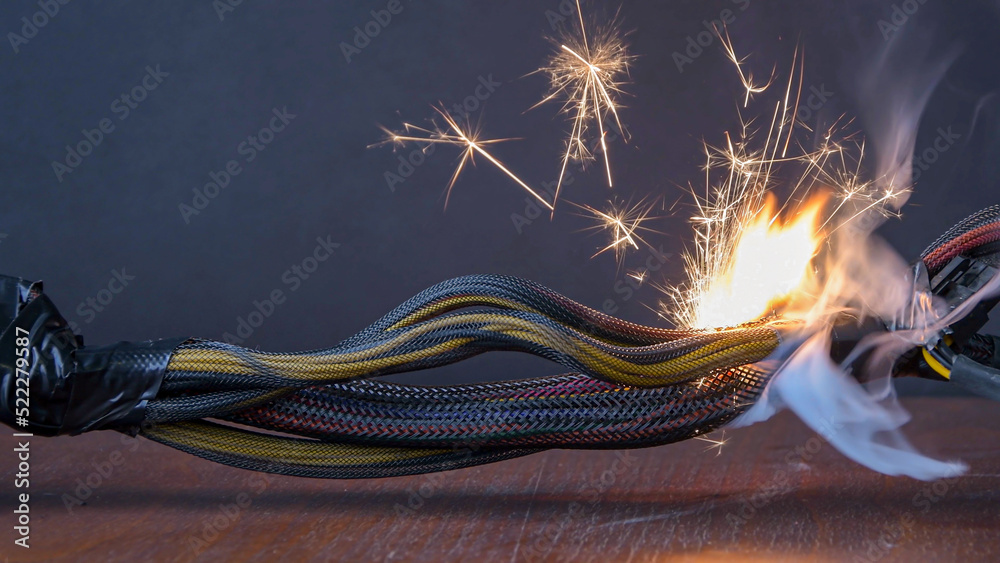 Electrical wiring and wires are lit on a dark background. A short ...