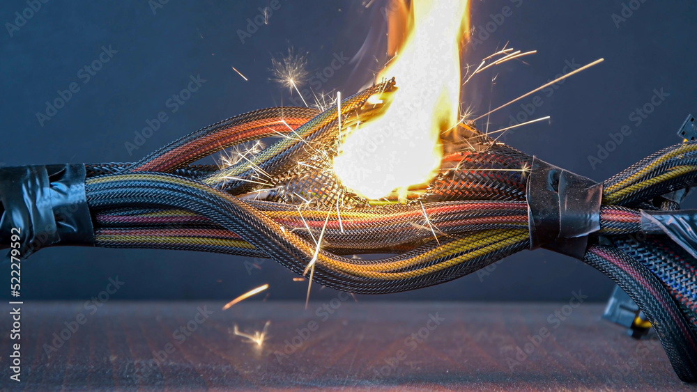 Electrical wiring and wires are lit on a dark background. A short ...