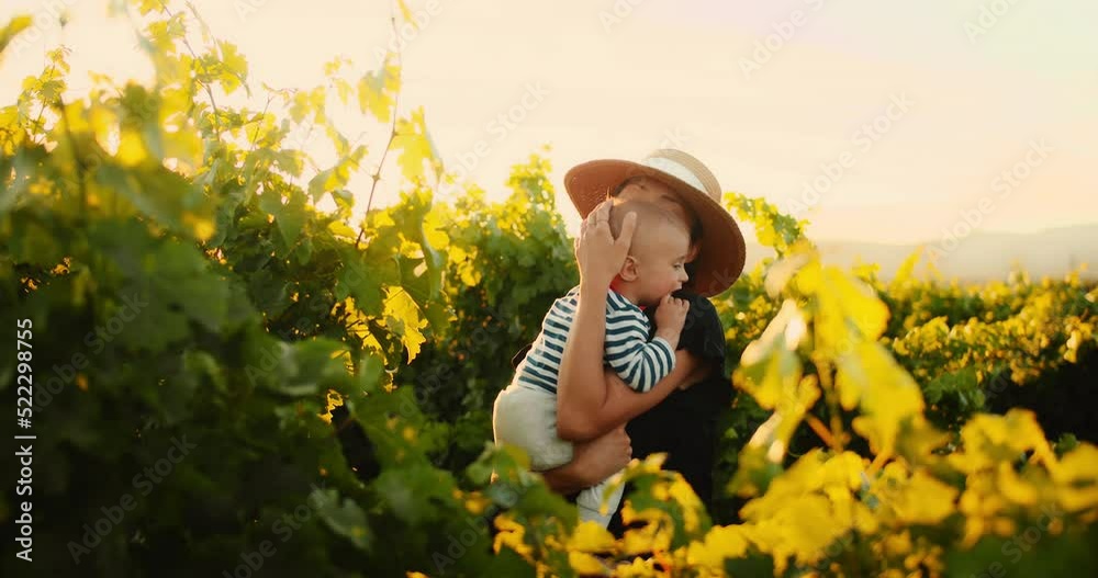 Young beautiful woman in dress having good time with her little child ...