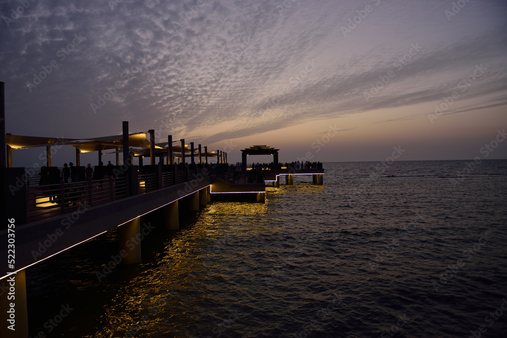 Jeddah's Corniche Beach, after a beautiful sunset and with decorative ...