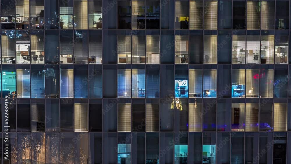 Night aerial view of office building glass window facade with ...