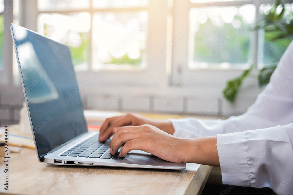 Back to school. Close up hands of female using computer sitting at ...