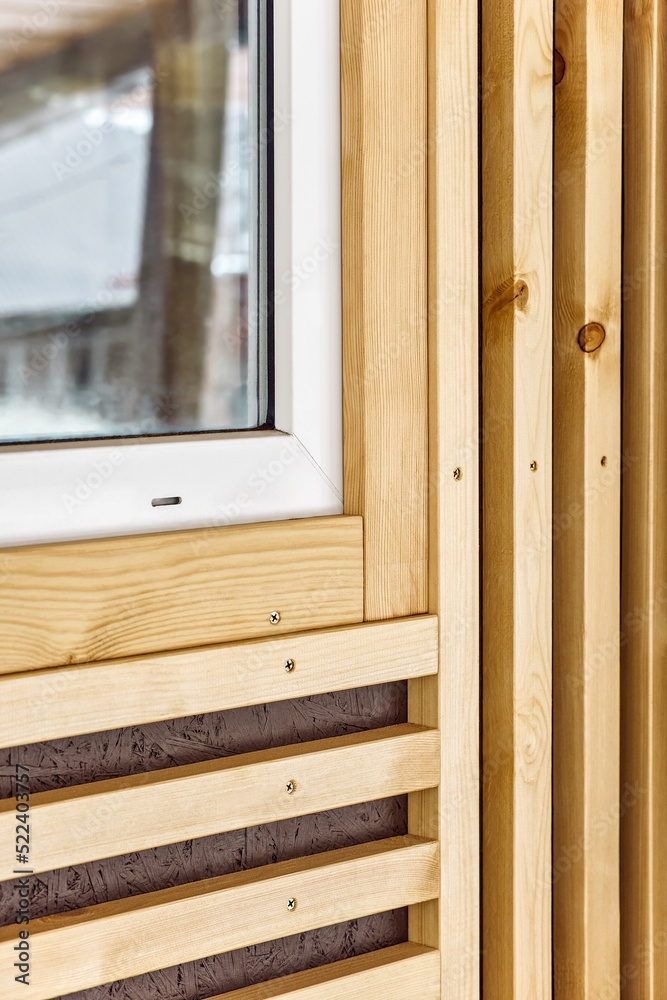 Building wall and window decorated with stylish wooden slats made of ...