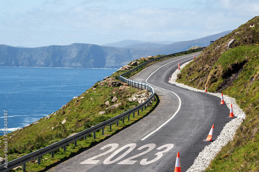 Sign 2023 on a mountain road with bends and warning orange and white ...