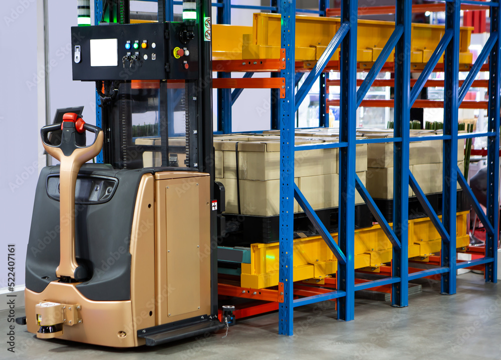 Automated Guided Vehicles (AGV) forklift lifting carton in modern ...