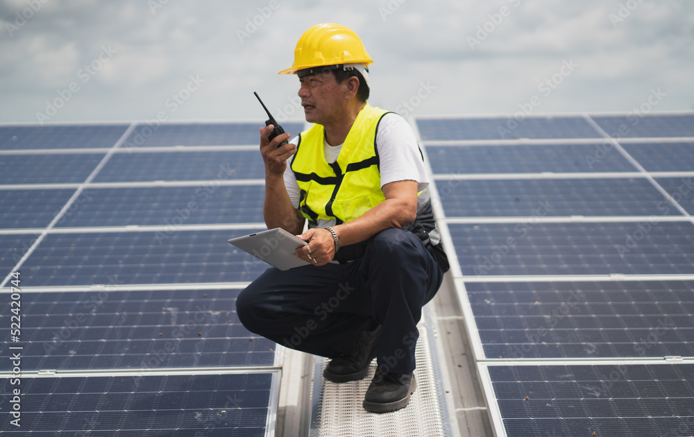 Construction workers clean solar panels for energy.Renewable Energy ...