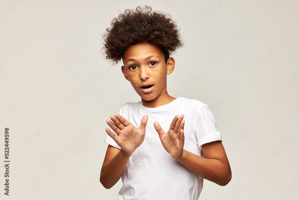 Portrait of scared african american boy terrified and panicked showing ...