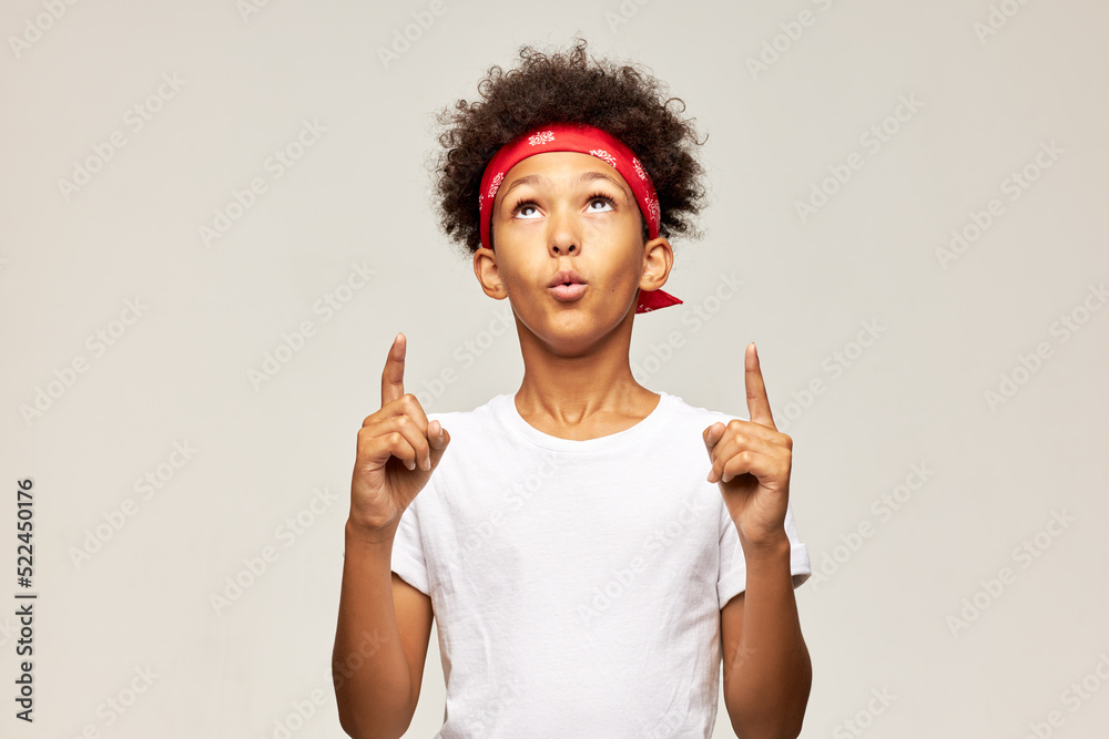 Amazed surprised african american teen boy in red bandana and white ...
