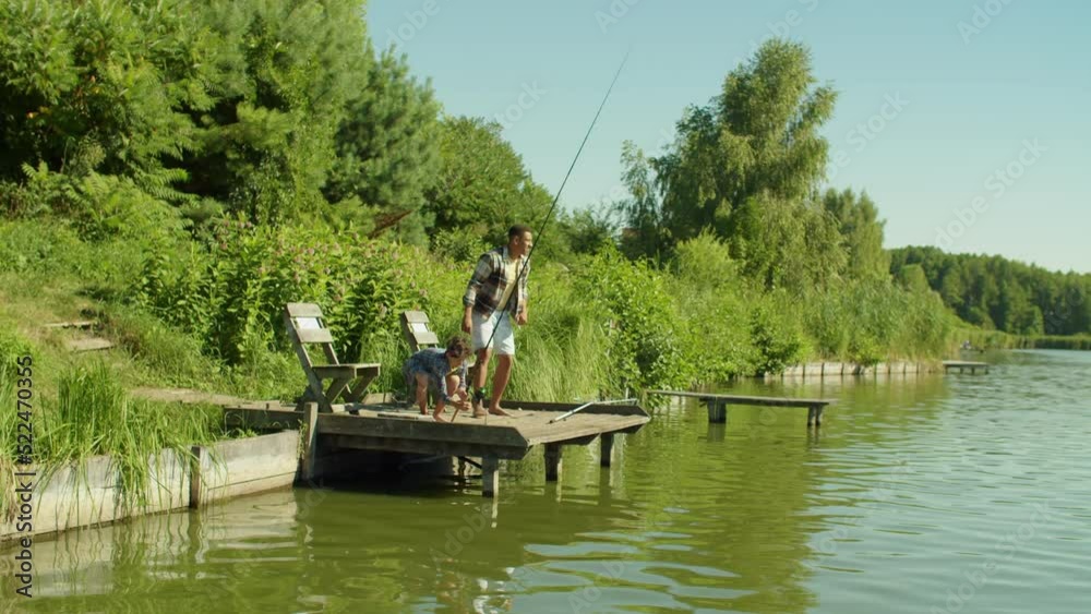 Excited joyful adorable multiracial teenage fisherman catching fish ...