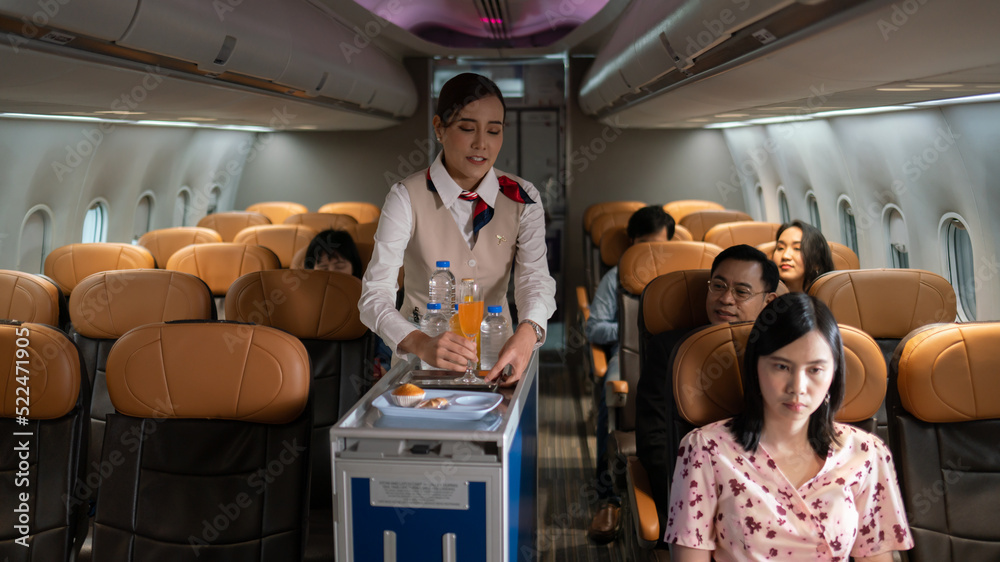 Female flight attendants in the cabin of the plane prepare lunch and ...