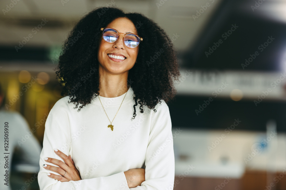 Confident young businesswoman smiling at the camera Stock Photo | Adobe ...