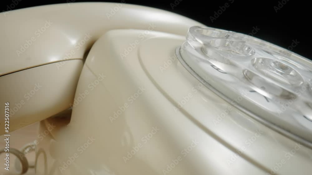 Old rotary telephone with dialer, handset and twisted cord on isolated ...