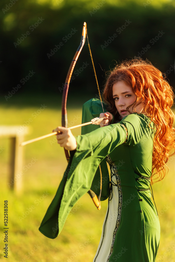 mysterious red-haired warrior girl stands. Lady elven princess holds ...