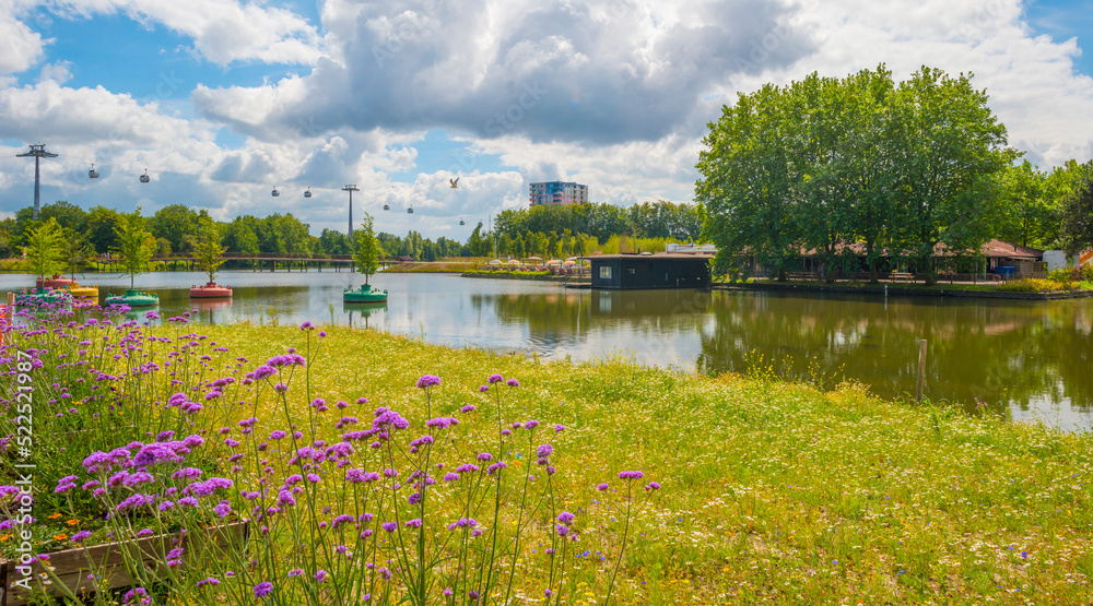 Cable car over a park in a blue and bright sky in summer, Almere ...